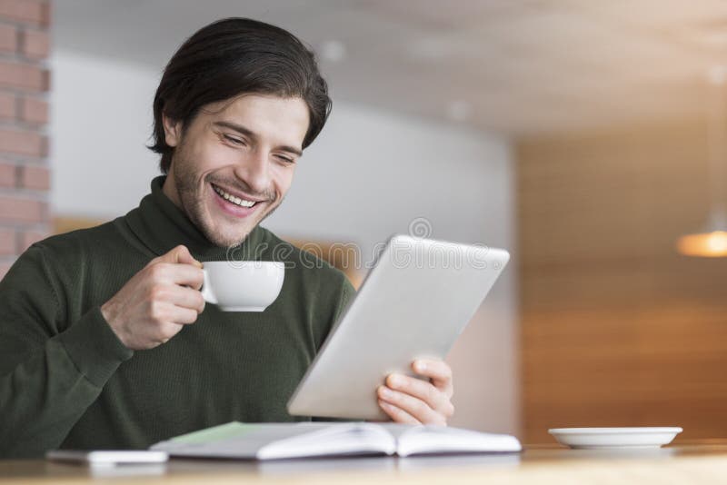 Happy Young Man Reading Emails while Drinking Coffe at Cafe Stock Image ...