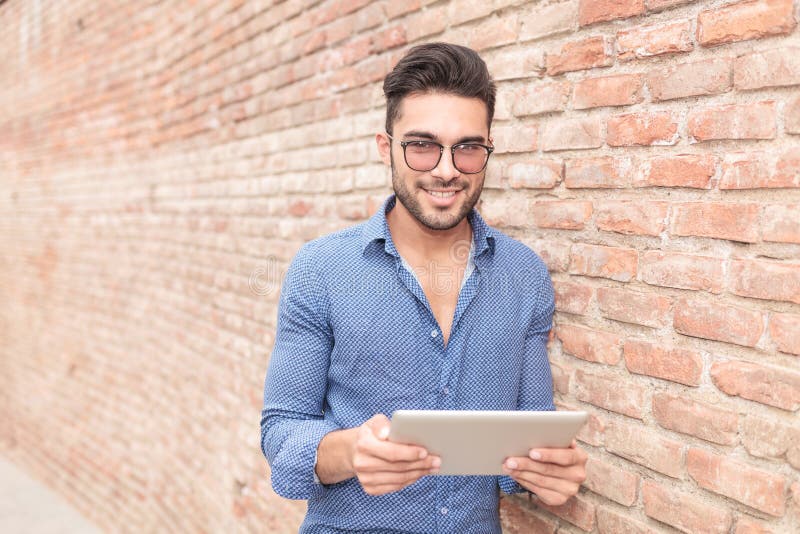 Happy Young Man Reading on a Tablet Computer Stock Photo - Image of ...