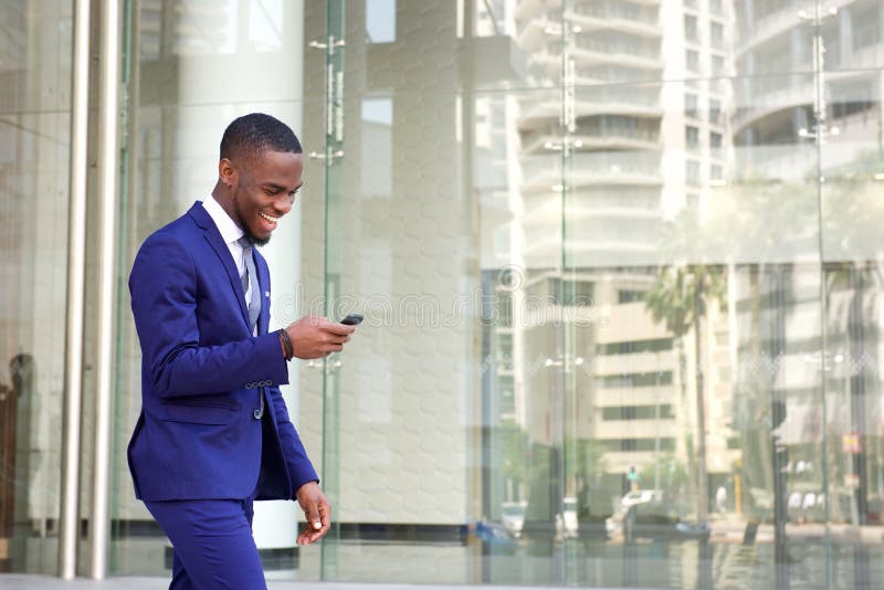Happy Young Man Reading Text Message on His Mobile Phone Stock Photo ...