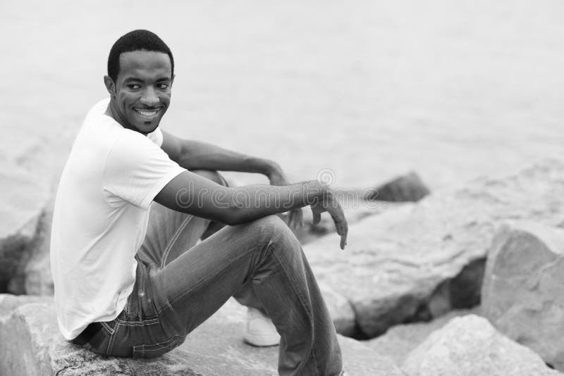 Happy Young Man on the Rocks Stock Image - Image of composition, black ...
