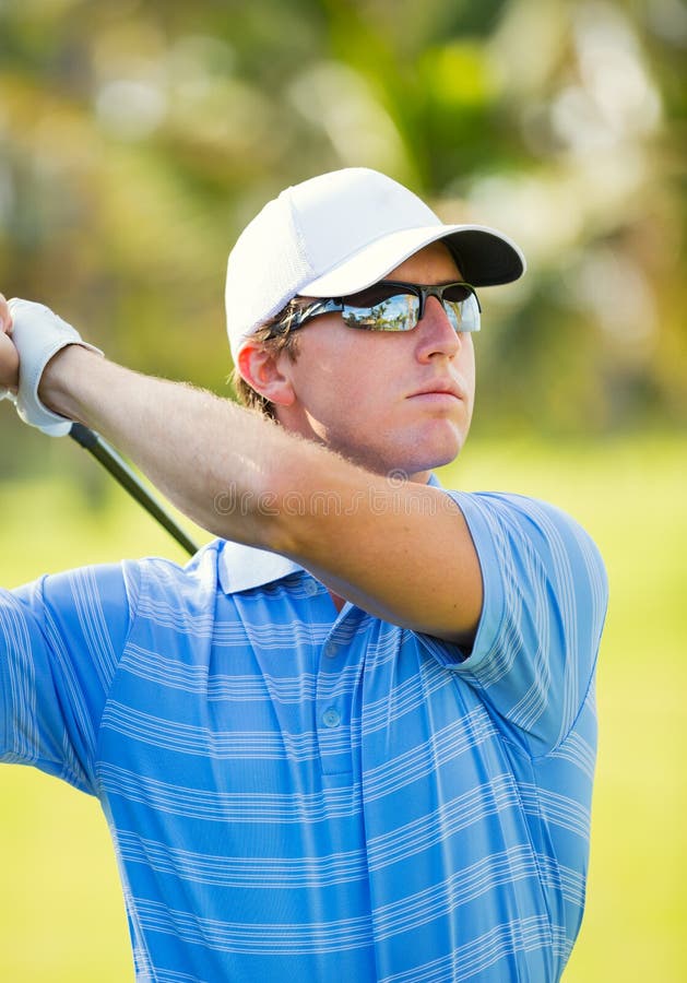 Happy Young Man Swinging Golf Club Stock Photo - Image of active ...