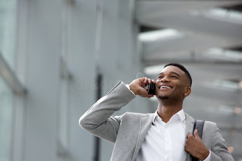 Happy Young Man Talking on Mobile Phone Inside Building Stock Photo ...