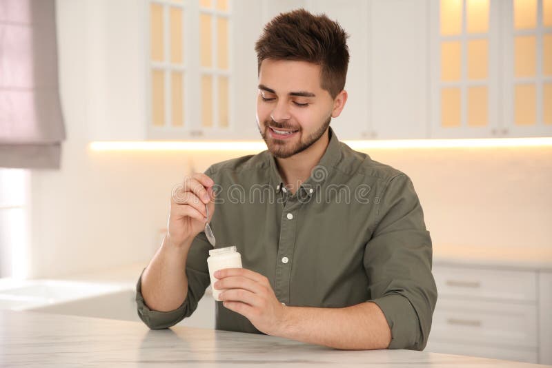Happy Man with Tasty Yogurt at Table in Kitchen Stock Image - Image of ...