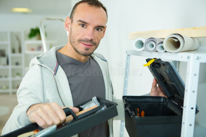 Happy young man with tools stock photo. Image of room - 186146686