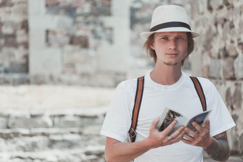 Happy young man with a map stock photo. Image of smile - 100605656