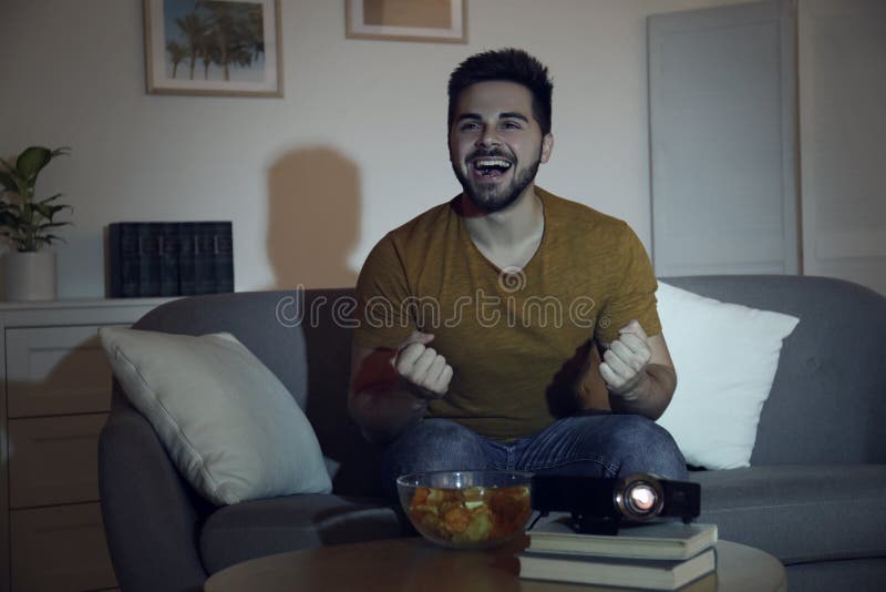 Happy Young Man Watching Movie Using Video Projector Stock Image ...