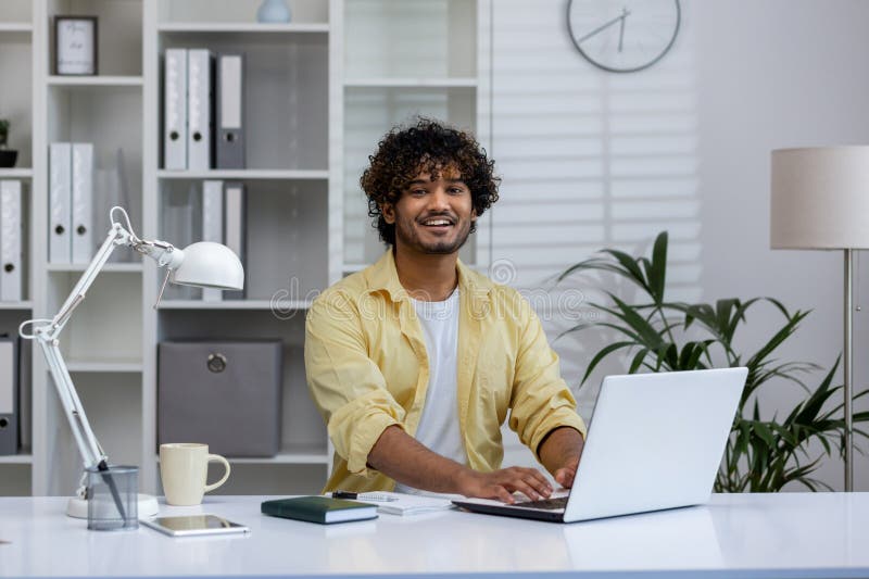 Happy Young Man Working on a Laptop in a Modern Office Environment ...