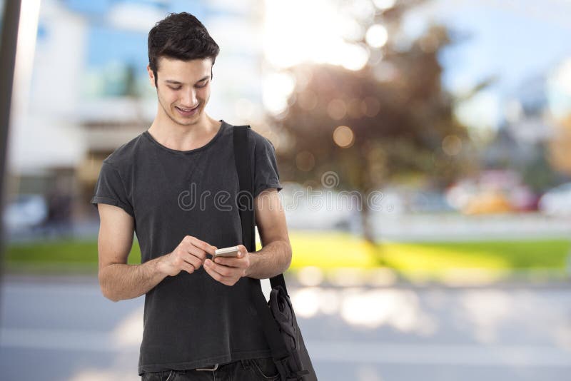 Happy Young Man Writing Message on Mobile Phone Stock Image - Image of ...