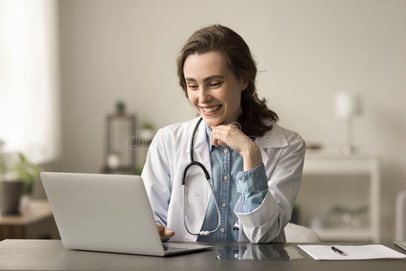 Happy Young Medical Practitioner Woman Working at Laptop Stock Photo ...