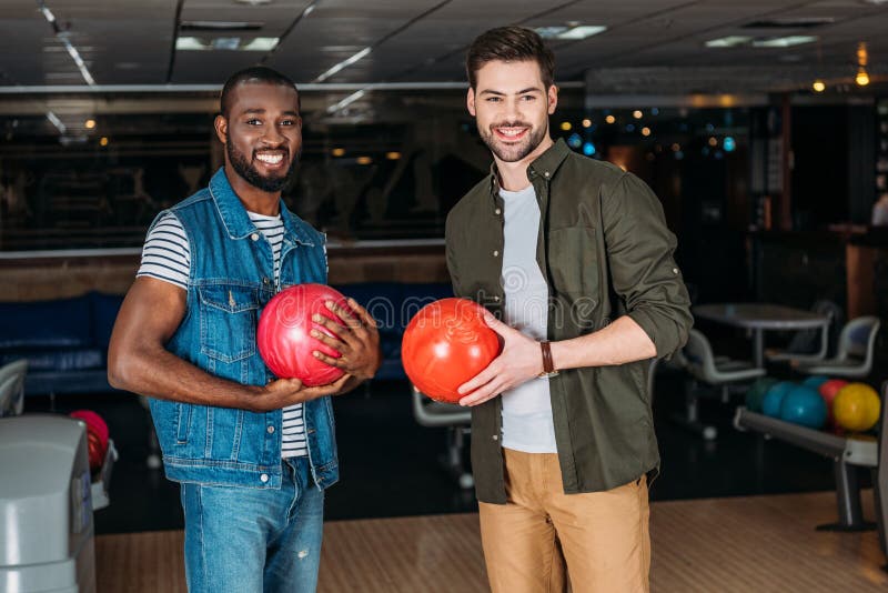 Happy Young Men with Balls at Bowling Club Looking Stock Image - Image ...