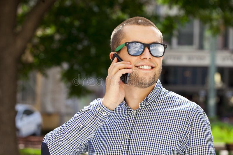Happy Young Men Calling by Phone Stock Photo - Image of shirt ...