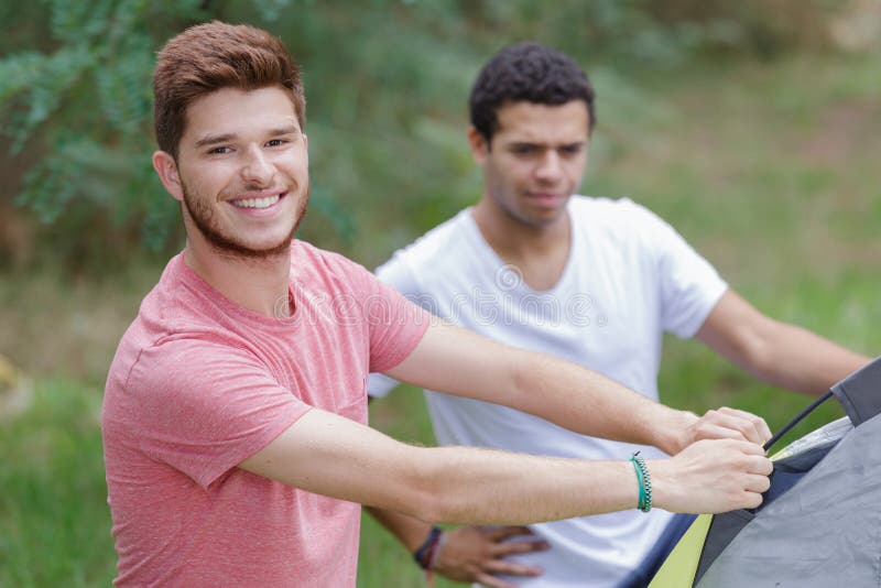 Happy young men camping stock photo. Image of traveler - 254756166