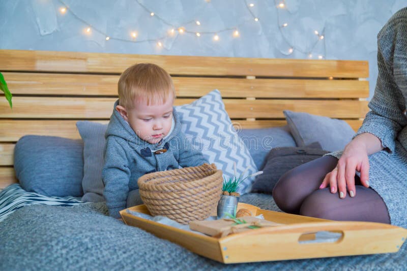 Happy Young Mother and Her Baby Son Playing with Walnuts Stock Photo ...