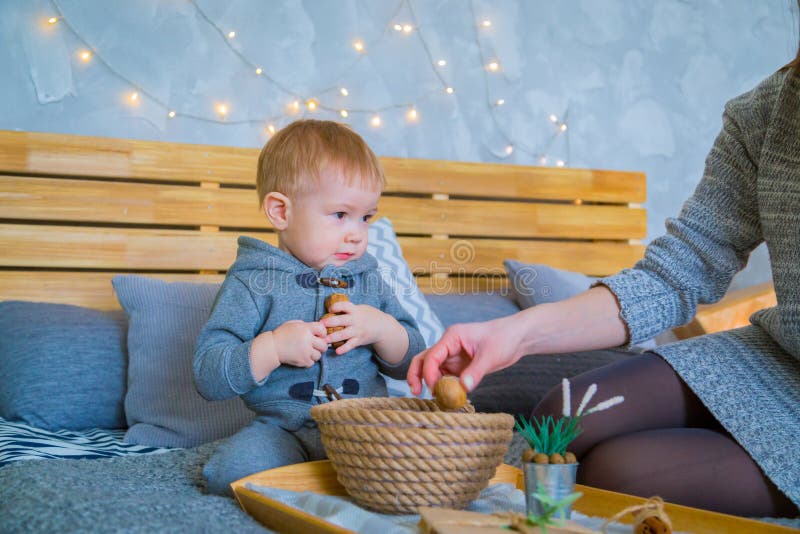 Happy Young Mother and Her Baby Son Playing with Walnuts Stock Photo ...