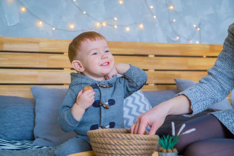 Happy Young Mother and Her Baby Son Playing with Walnuts Stock Photo ...