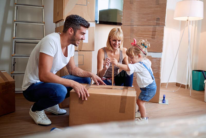 Happy Parents with Child Moving in New Home Unpacking Boxes Stock Photo ...