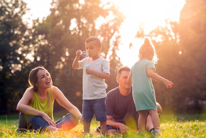 Happy Parents Playing with Children Outside Stock Photo - Image of ...