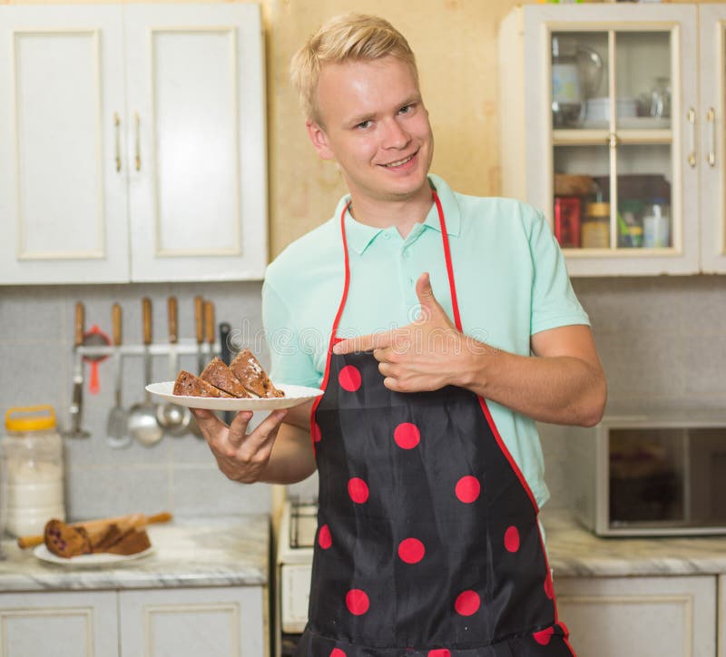 Happy Young Pastry Chef, a Man Proudly Holds Cooked Pie Stock Photo ...