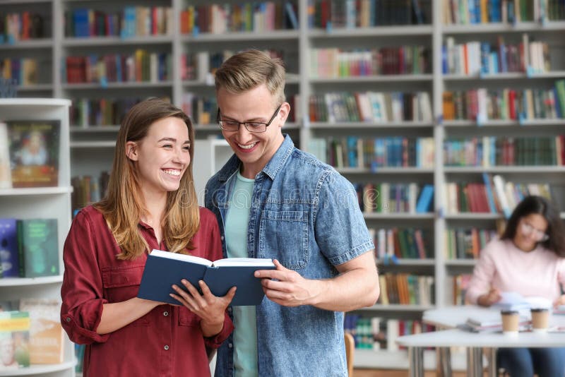 Happy Young People with Book in Library. Space for Stock Image - Image ...