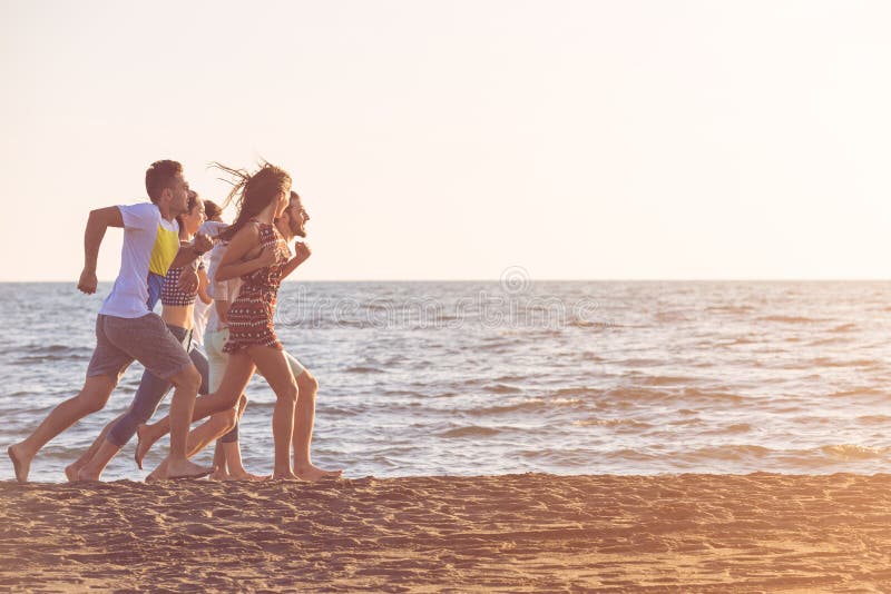 Happy Young People Group Have Fun White Running and Jumping on Beach at ...