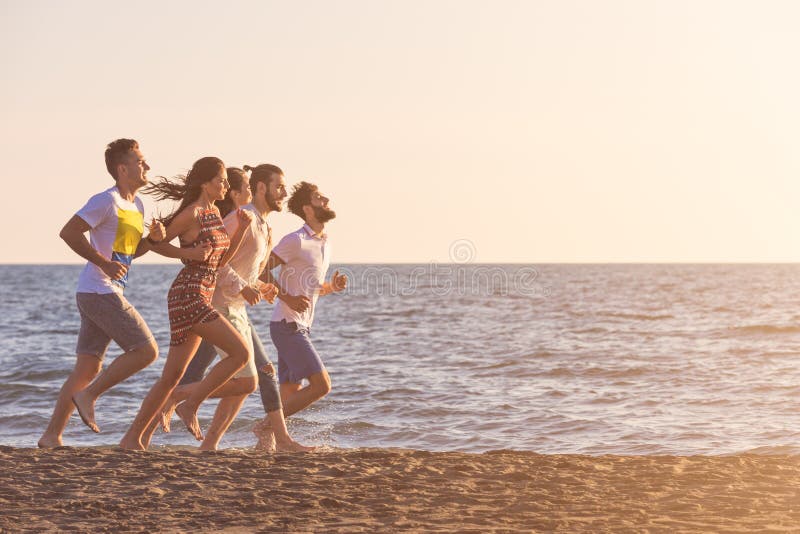 Happy Young People Group Have Fun White Running and Jumping on Beach at ...