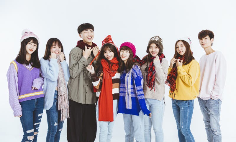 Happy Young People in Winter Clothes Standing Together Stock Photo ...