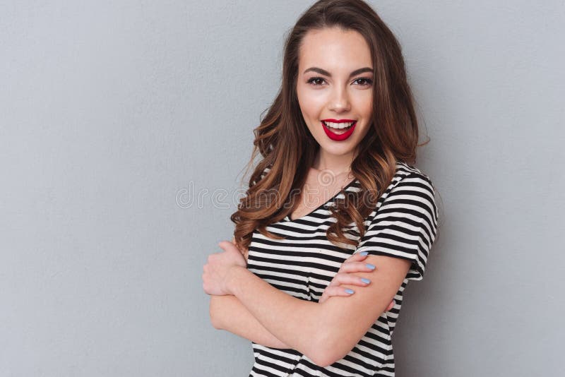 Happy Young Pretty Lady Standing Over Grey Wall. Stock Photo - Image of ...