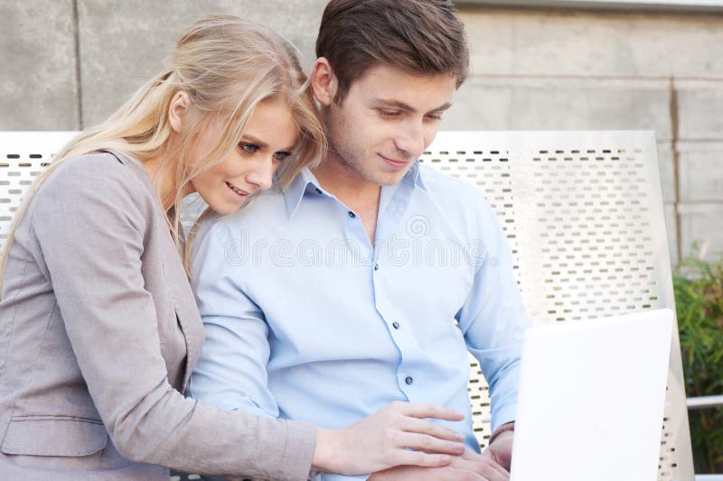 Happy, Young Professional Couple Using Laptop Stock Photo - Image of ...