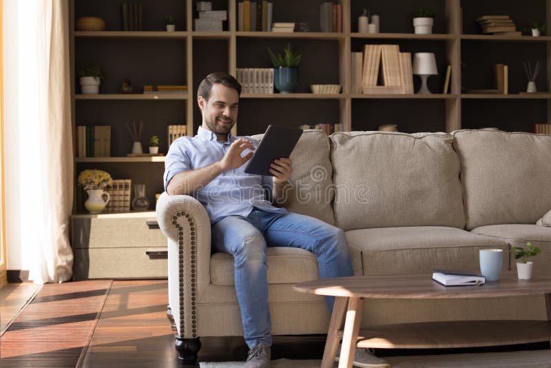Happy Young Relaxed Man Using Digital Touchpad Gadget. Stock Photo ...