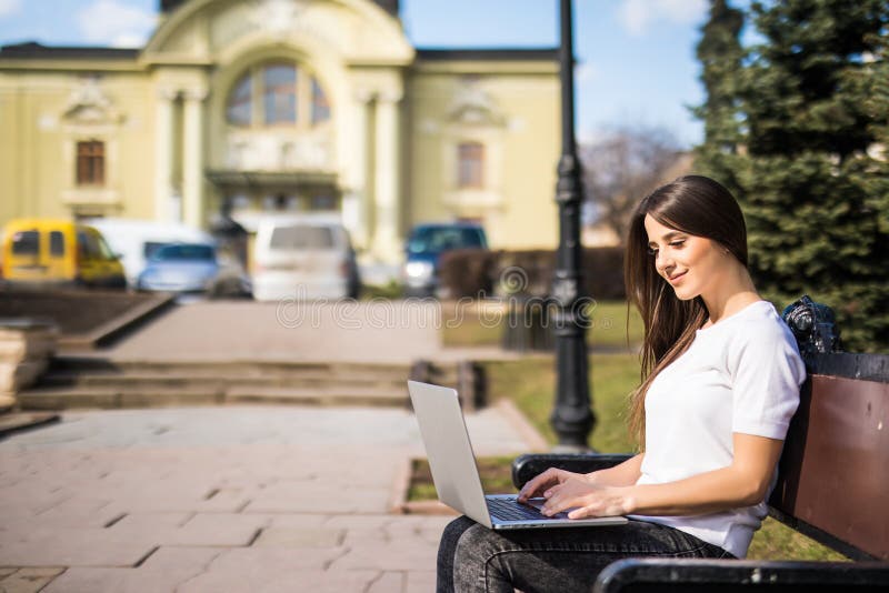 Happy Young Student with Laptop Sitting on the Bench Stock Photo ...