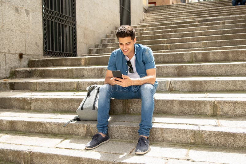 Happy Young Student Male Texting on His Smart Phone in Modern City ... Happy Young Student Male Texting on His Smart Phone in Modern City ...