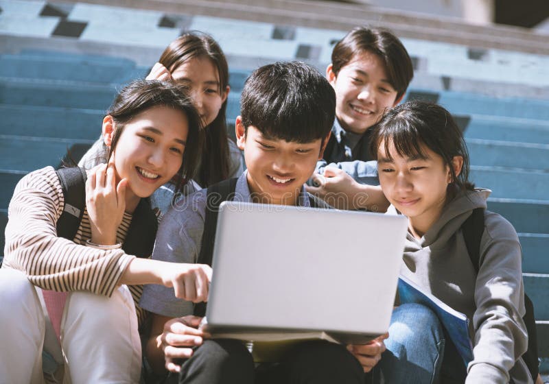 Happy Young Students Looking at Laptop and Sitting on the Stairs Stock ...