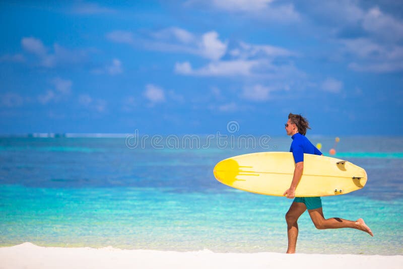 Happy Young Surf Man Runing at the Beach with a Stock Photo - Image of ...