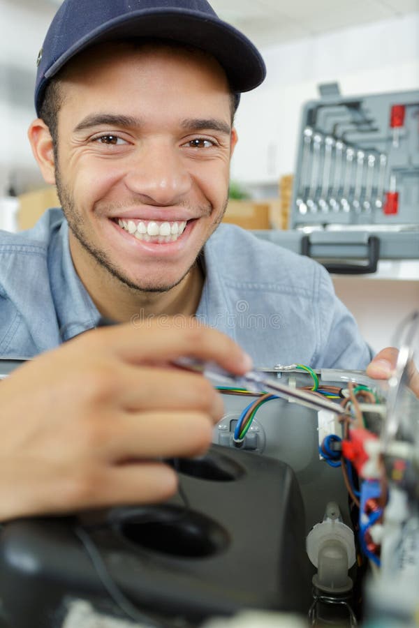 Happy Young Technician at Work Stock Photo - Image of room, person ...