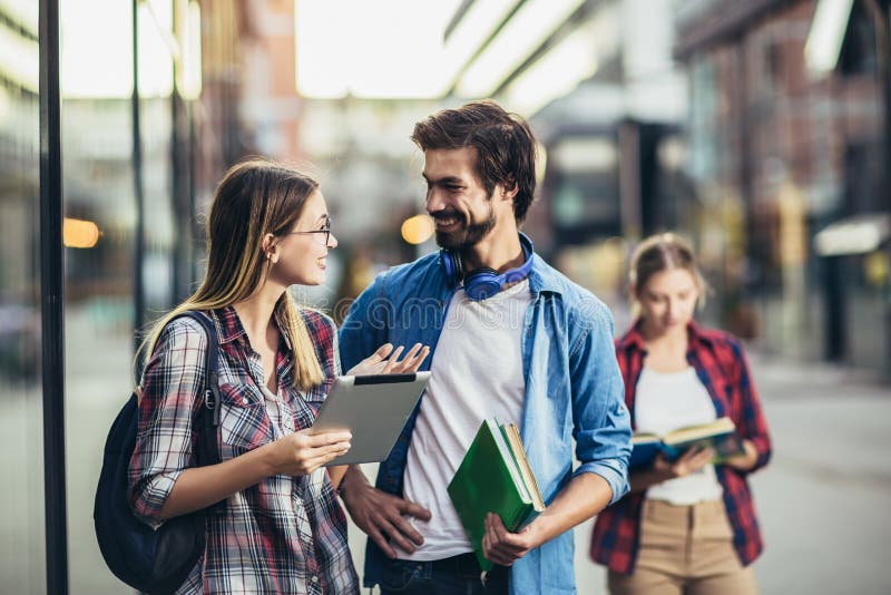 Young University Students Friends Studying with Books and Digital ...