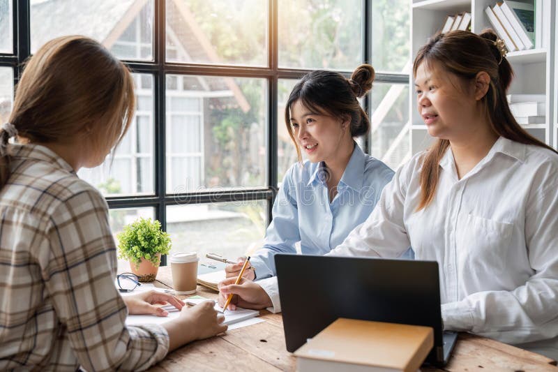 University Students Sitting Together at Table with Books and Laptop and ...