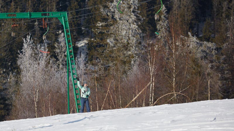 Happy Young Woman on Button Ski Lift Going Uphill Stock Image - Image ...