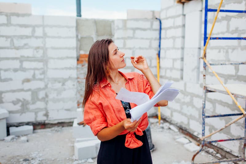 Young Woman Checks Her House Under Construction Comparing Progress with ...