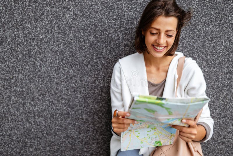 Happy Young Woman with a City Map and a Backpack Smiling Stock Image ...