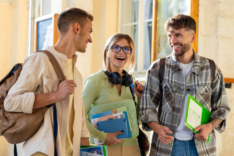 Happy Young Woman Collaborating with Her Classmates after Classes Stock ...