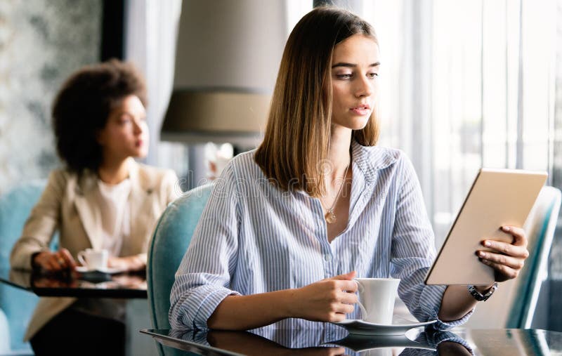 Happy Young Woman Drinking Tea and Using Tablet Computer Stock Photo ...