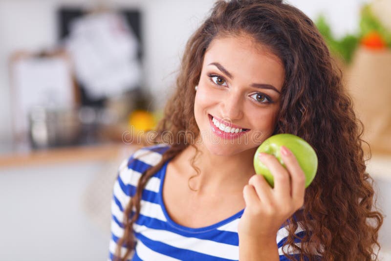 Happy Young Woman Eating Apples on Kitchen Stock Photo - Image of human ...