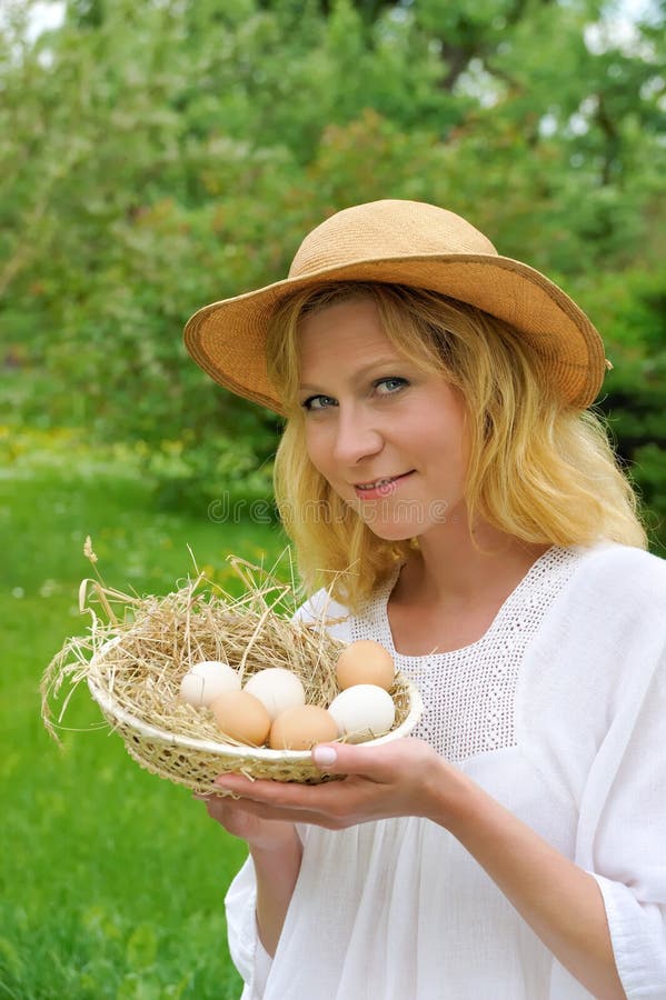 Happy young woman and eggs stock image. Image of domestic - 18036289