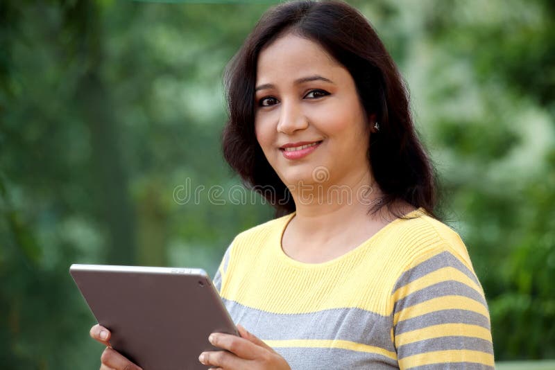 Happy Young Woman Holding Tablet Computer at Outdoor Stock Photo ...