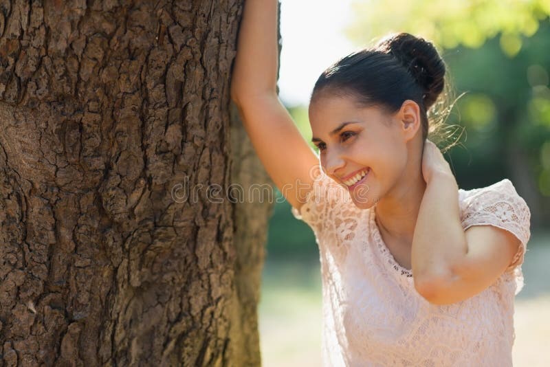 Thoughtful Young Woman Lean Against Tree Stock Image - Image of ...