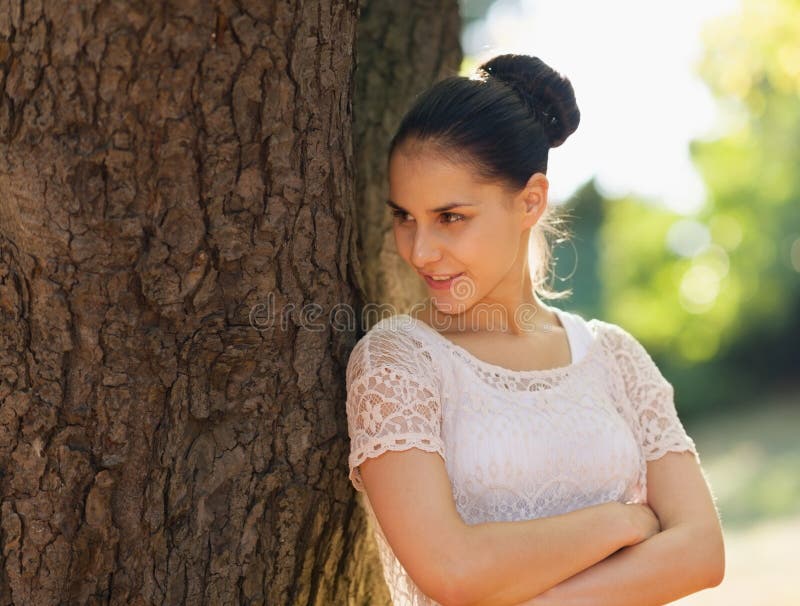 Happy Young Woman Lean Against Tree in Park Stock Image - Image of ...