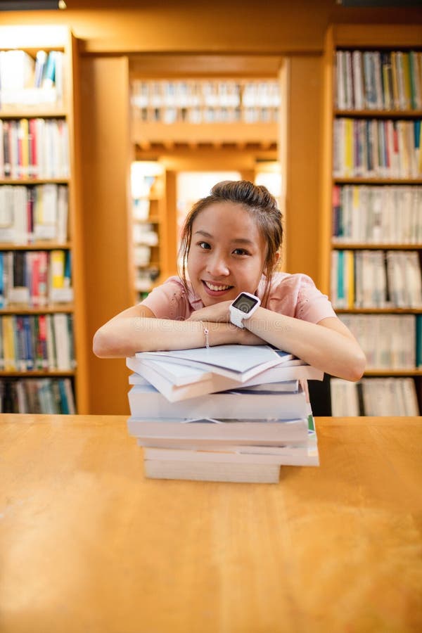 Happy Young Woman Leaning on Stack of Book Stock Photo - Image of ...