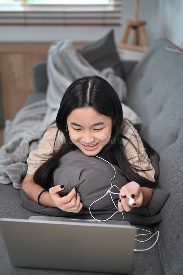 Happy Woman Lying on Sofa and Using Laptop Computer. Stock Photo ...
