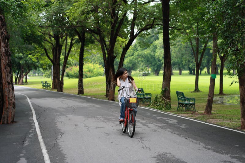Woman Riding a Bicycle stock image. Image of adult, active - 12387243