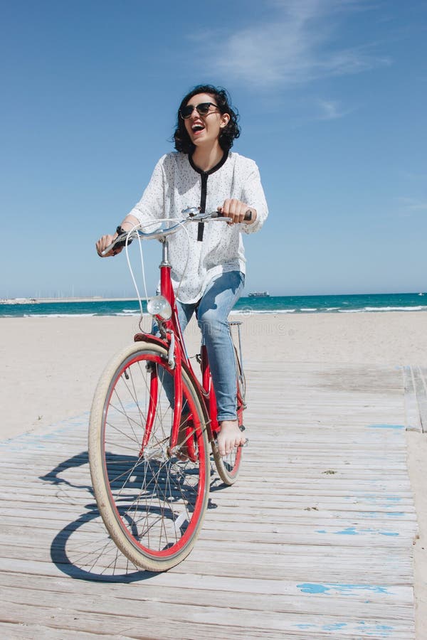 Happy Young Woman Riding a Bicycle on a Beach Stock Image - Image of ...